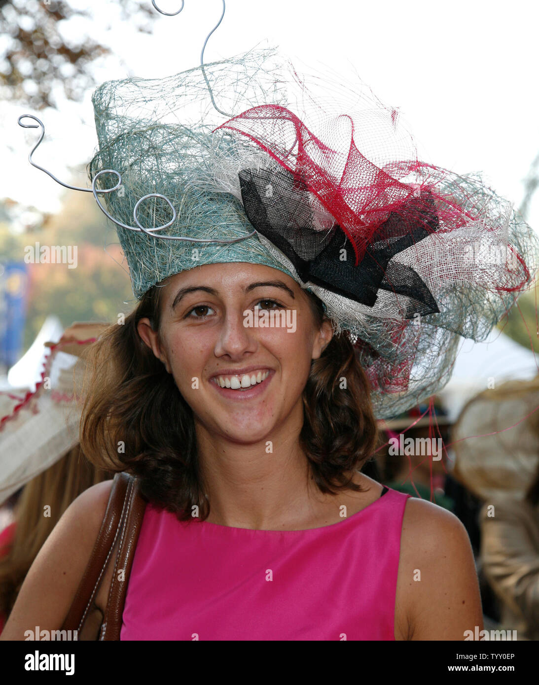 An entrant shows off her hat in the annual hat contest at the Prix de l ...