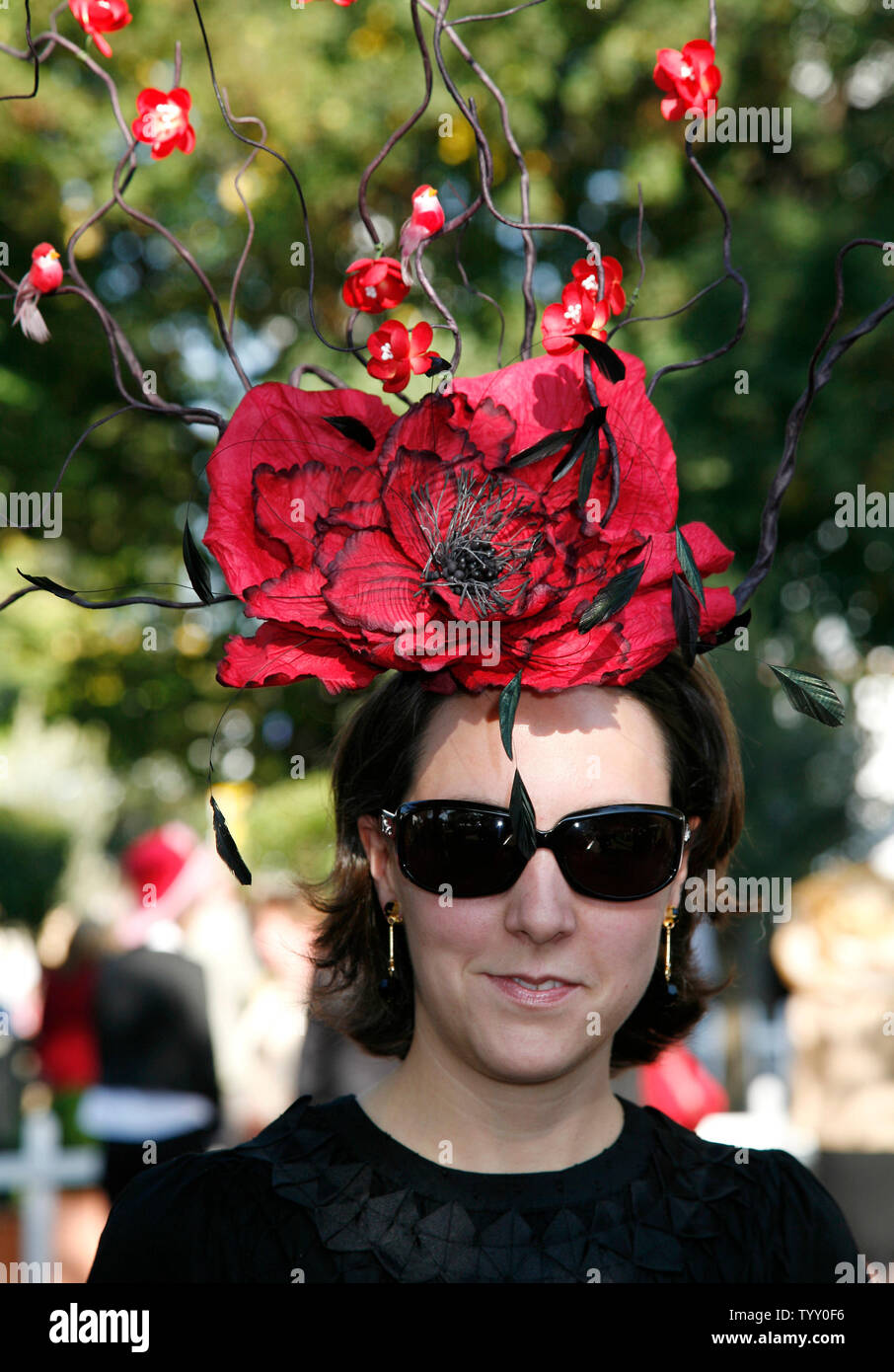 An entrant shows off her hat in the annual hat contest at the Prix de l ...