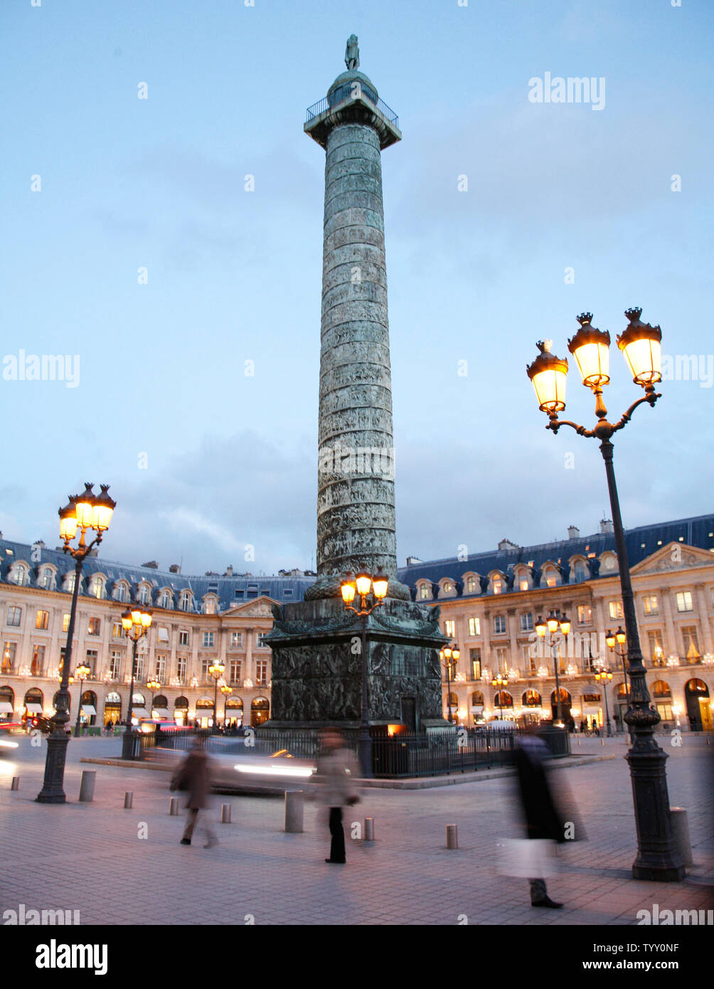 Pedestrians walk past the Colonne Vendome (Vendome Column) in the ...