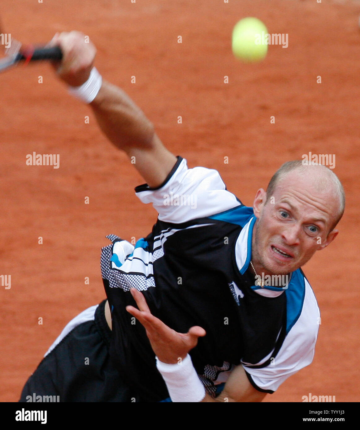 Russian Nikolay Davydenko hits a serve during his match with Thomas ...