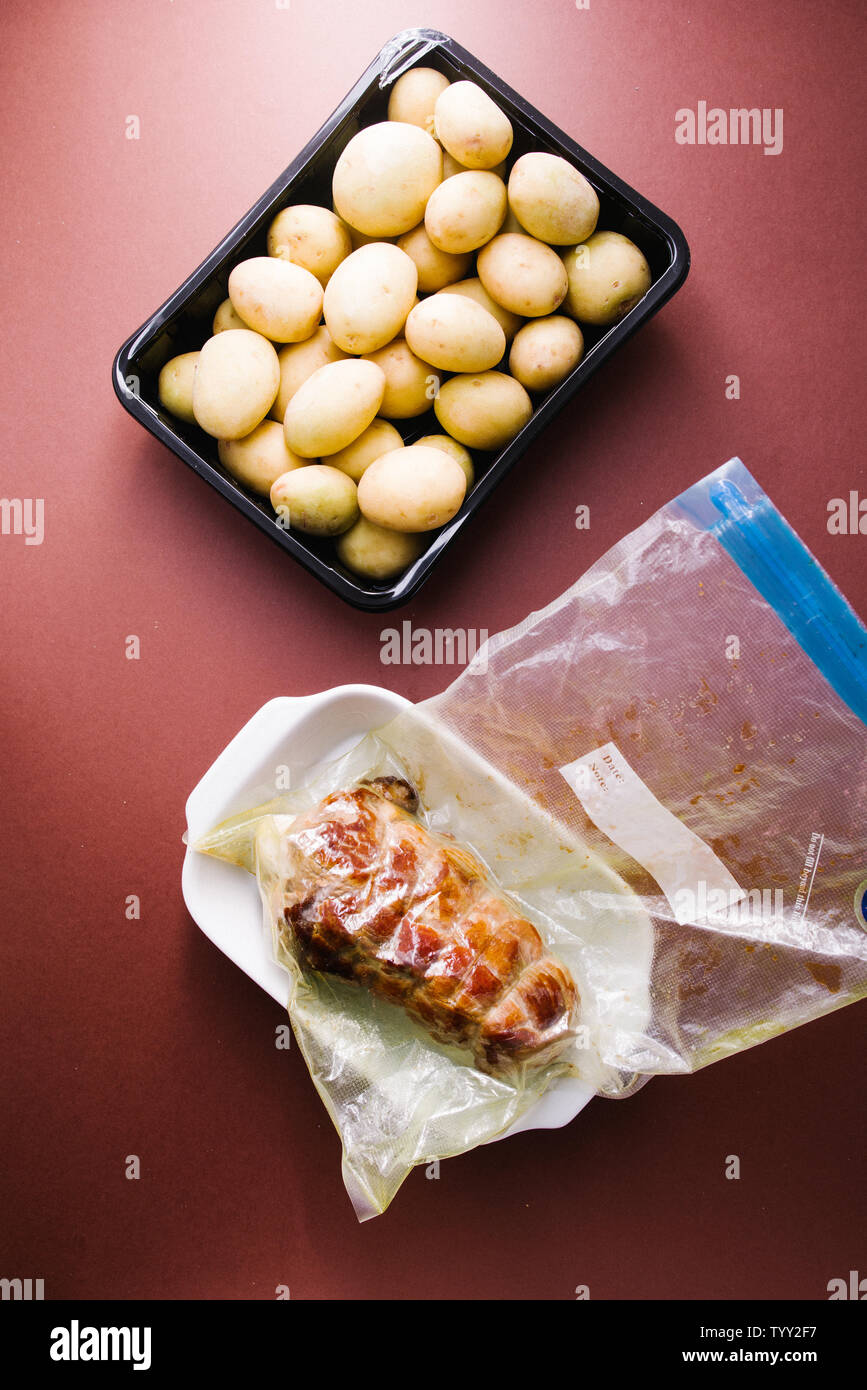 Raw roastbeef meat prepared, caparisoned with pig caul fat and rosemary ...