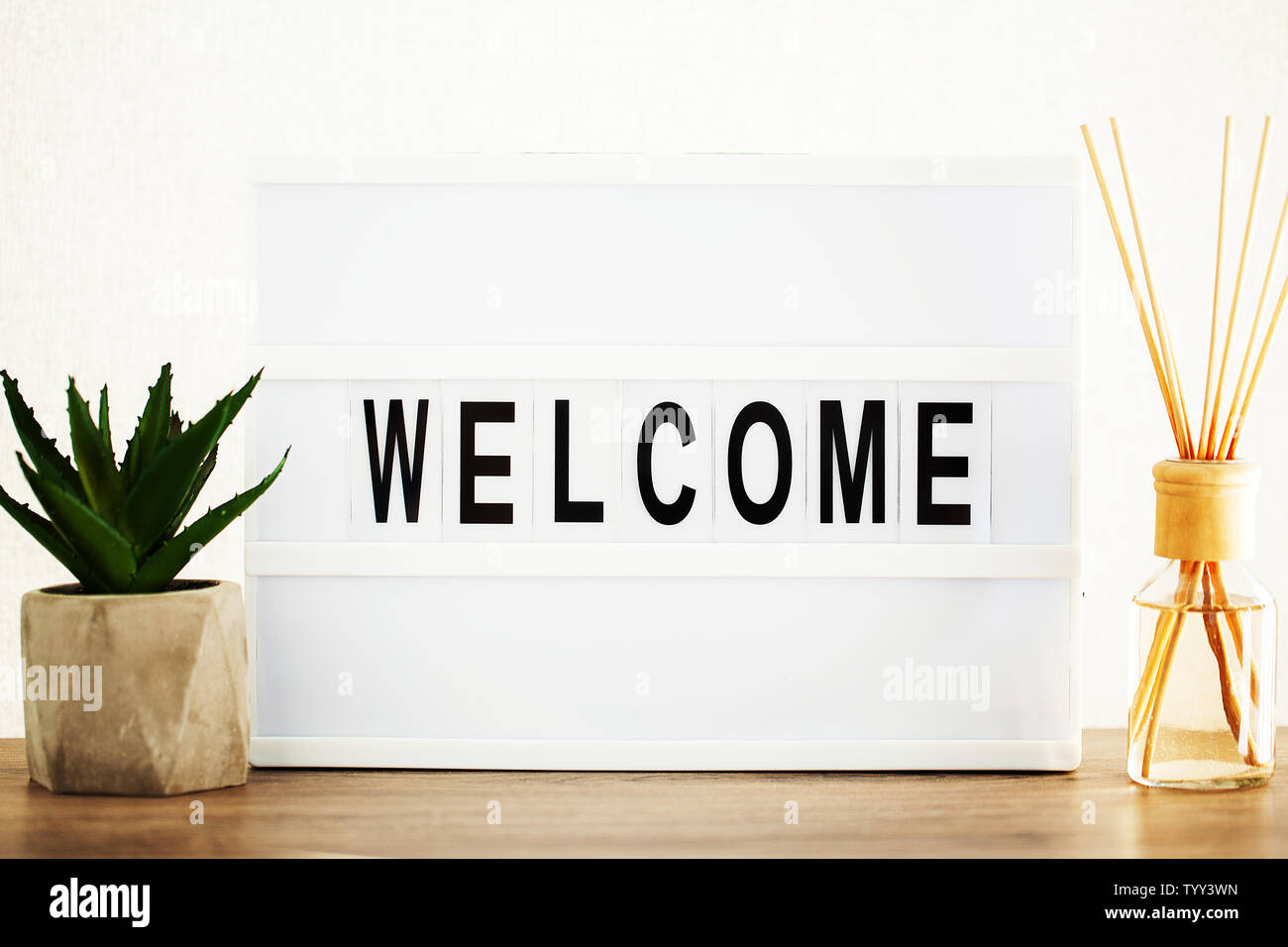 Led letter board with welcome word on table Stock Photo - Alamy
