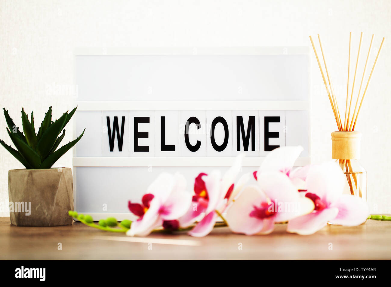 Led letter board with welcome word on table Stock Photo - Alamy