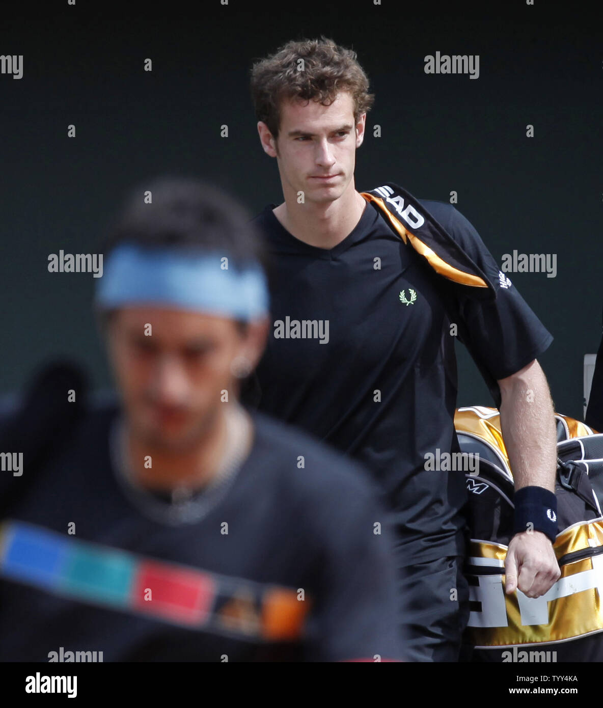 Andy Murray of Great Britain enters the court behind Italian Potito ...