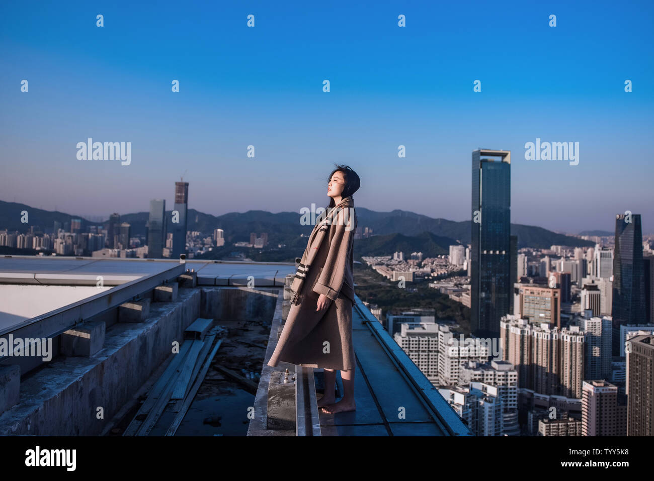 Girl on the rooftop Stock Photo - Alamy