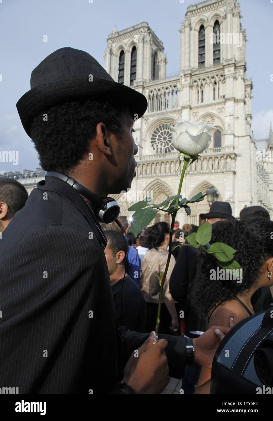A fan carries a rose to honor deceased singer Michael Jackson at a ...