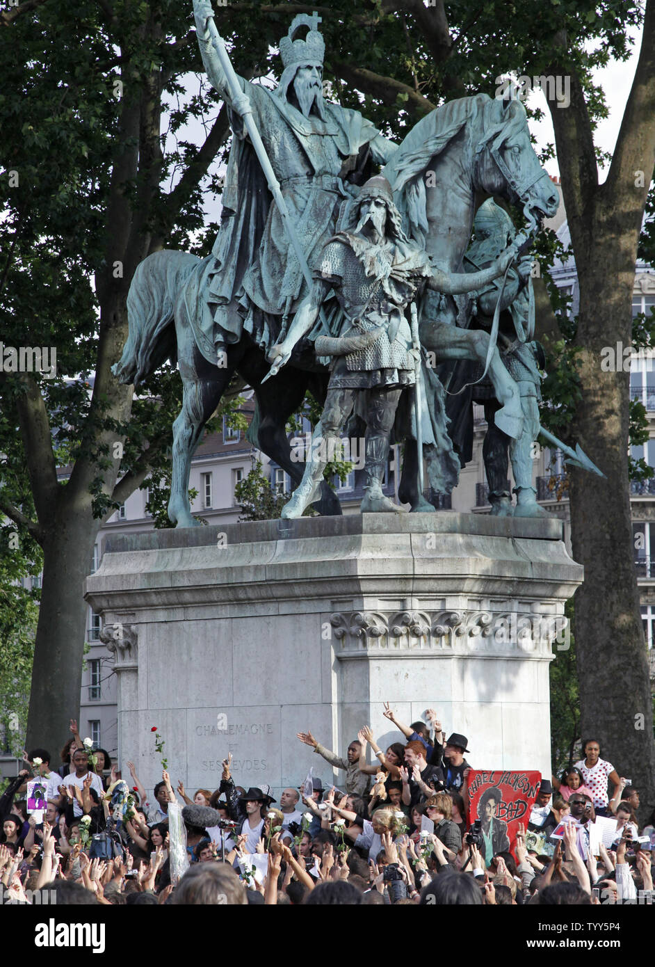 A crowd sings and salutes deceased singer Michael Jackson during a ...