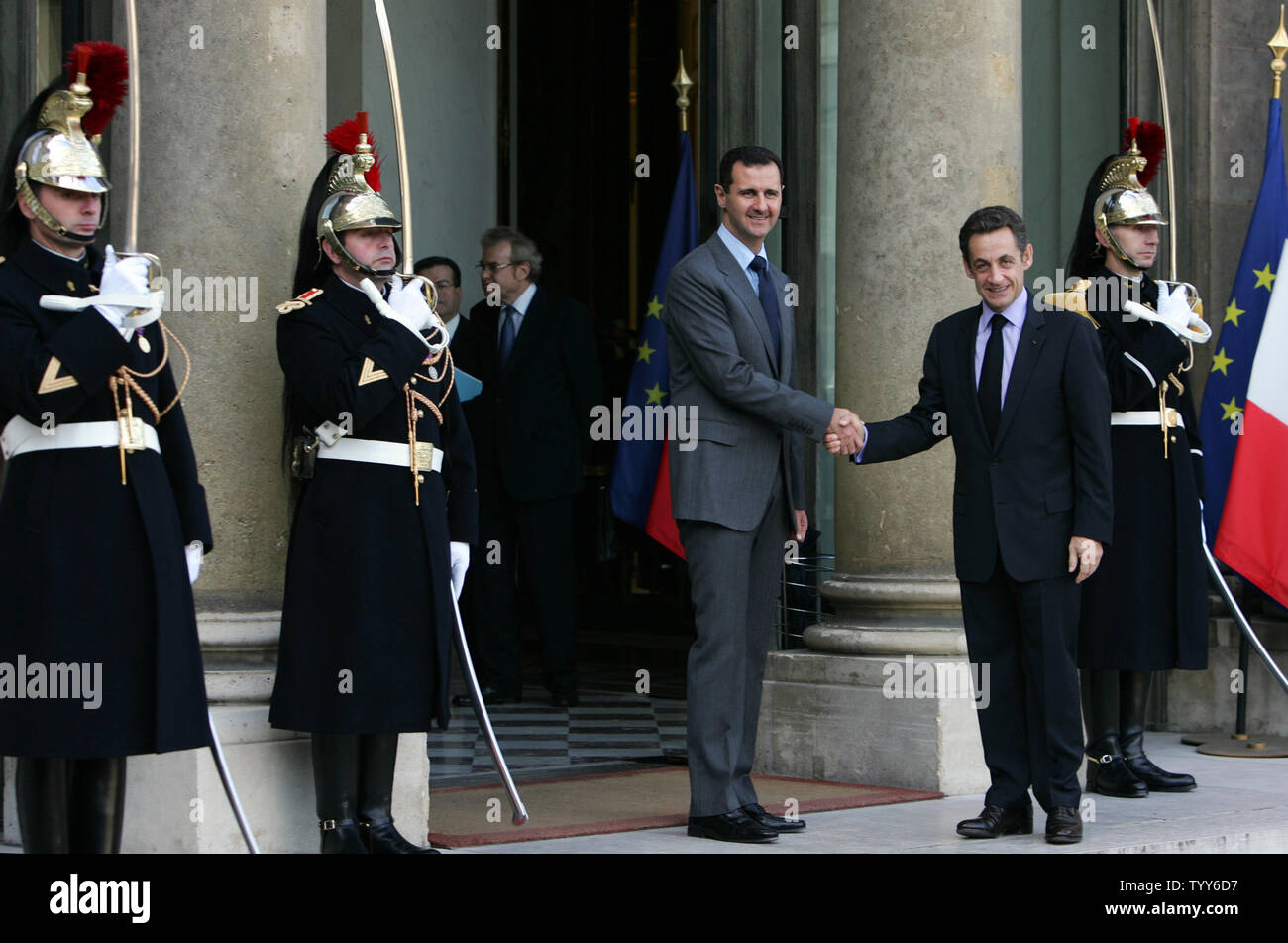 Syrian President Bashar al-Assad (L) shakes hands with French President ...