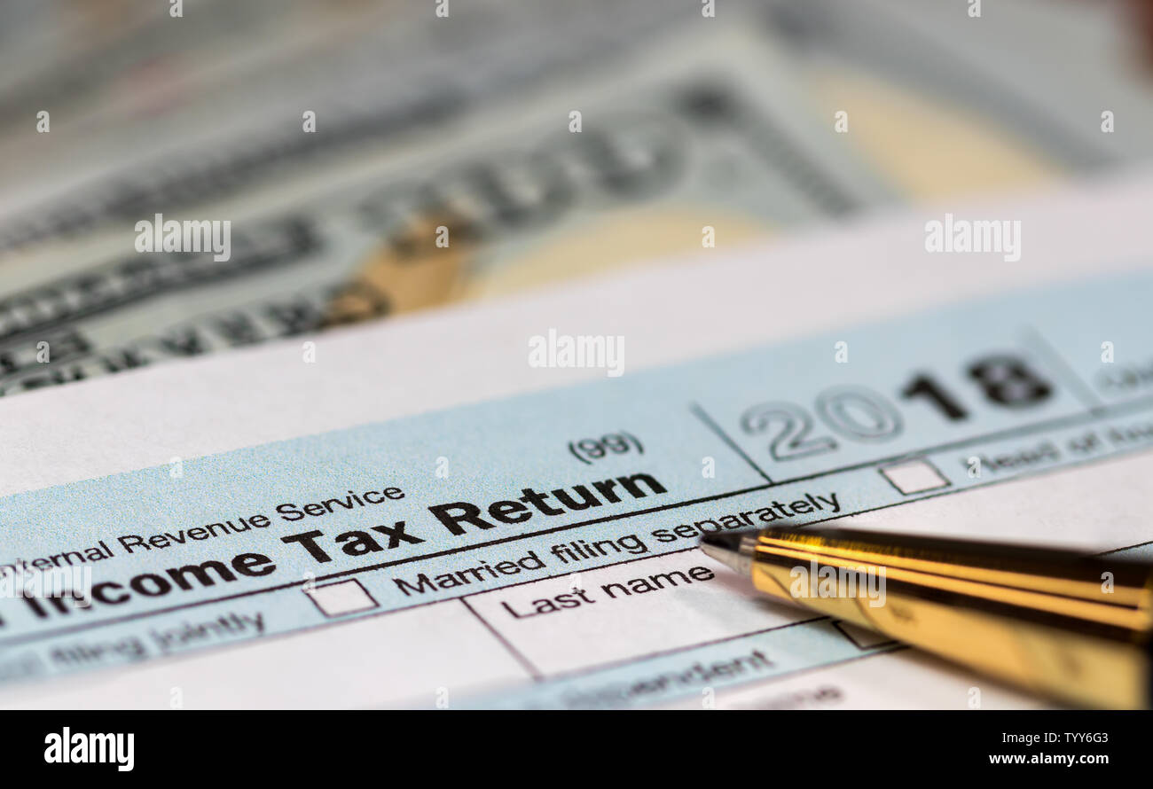 Federal income tax return form with pen and money on document Stock ...