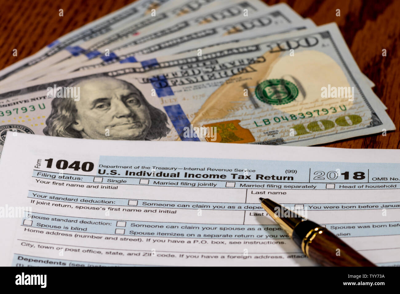 Federal income tax return form with pen and money on document Stock ...