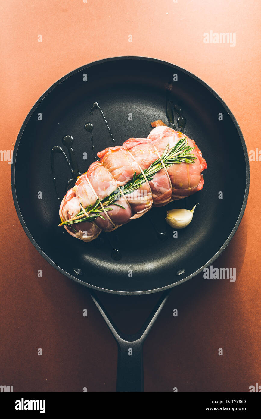 Raw roastbeef meat prepared, caparisoned with pig caul fat and rosemary ...