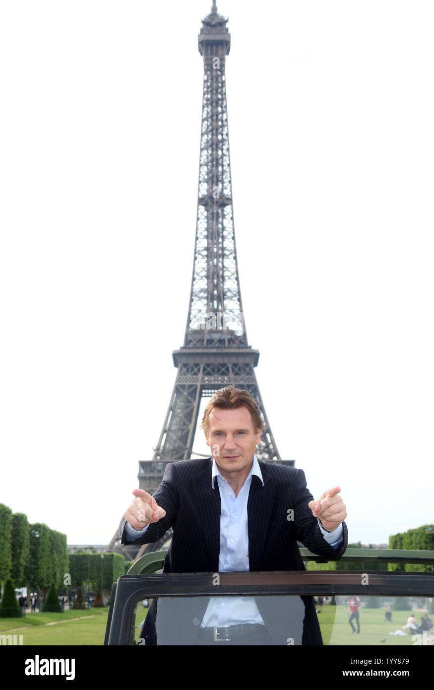 Liam Neeson arrives on the Champs de Mars in front of the Eiffel Tower ...