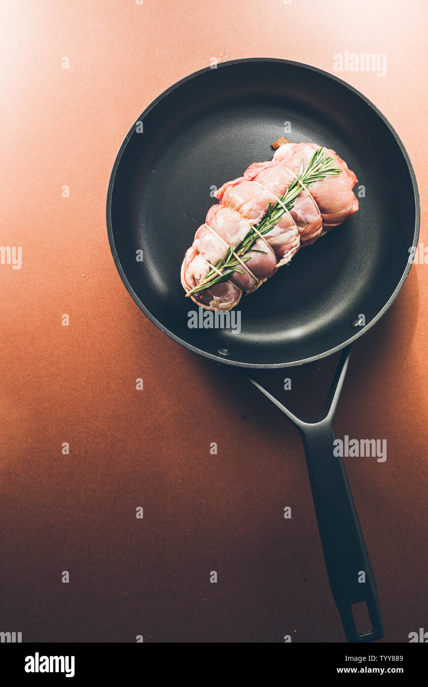 Raw roastbeef meat prepared, caparisoned with pig caul fat and rosemary ...