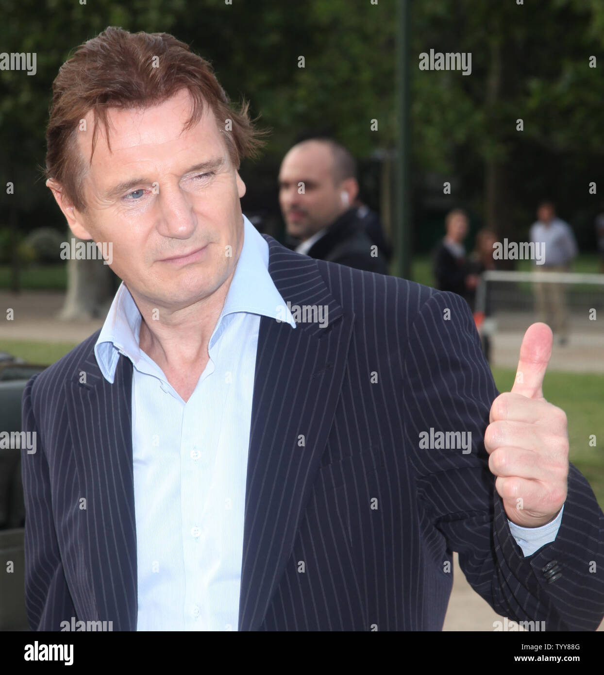 Liam Neeson arrives on the Champs de Mars in front of the Eiffel Tower ...