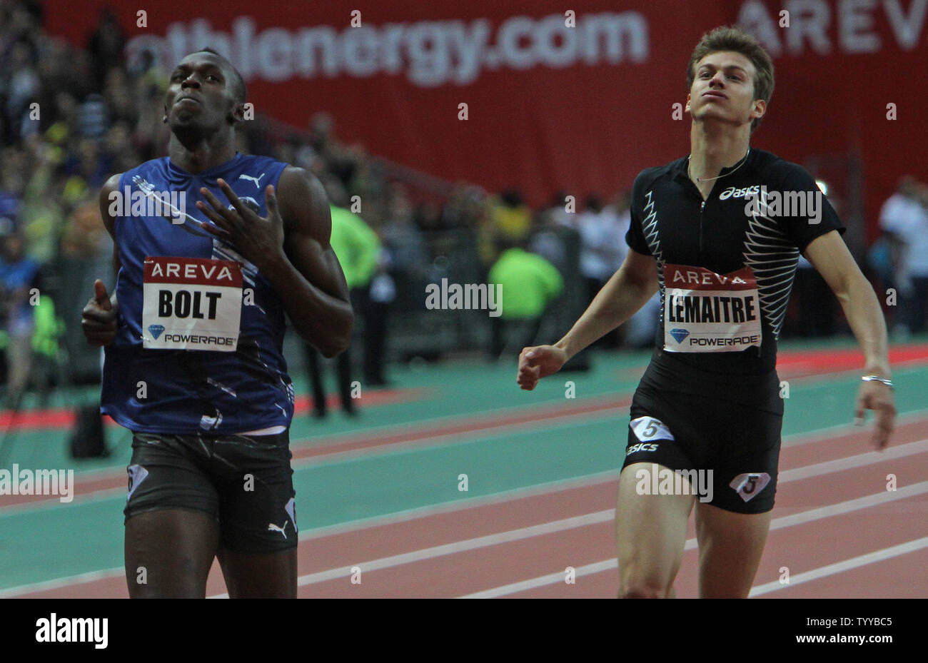 Usain Bolt (L) crosses the finish line ahead of Christophe Lemaitre to ...