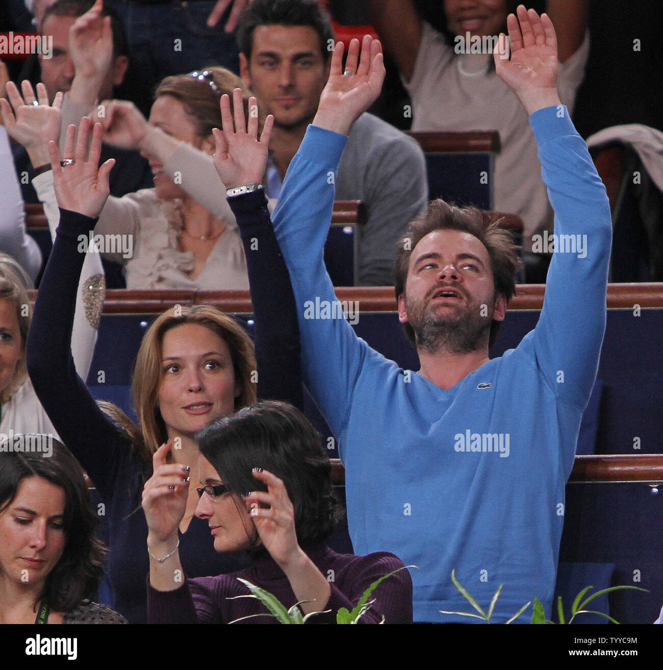 Actors Caroline Proust (L) and her husband Clovis Cornillac do the wave ...