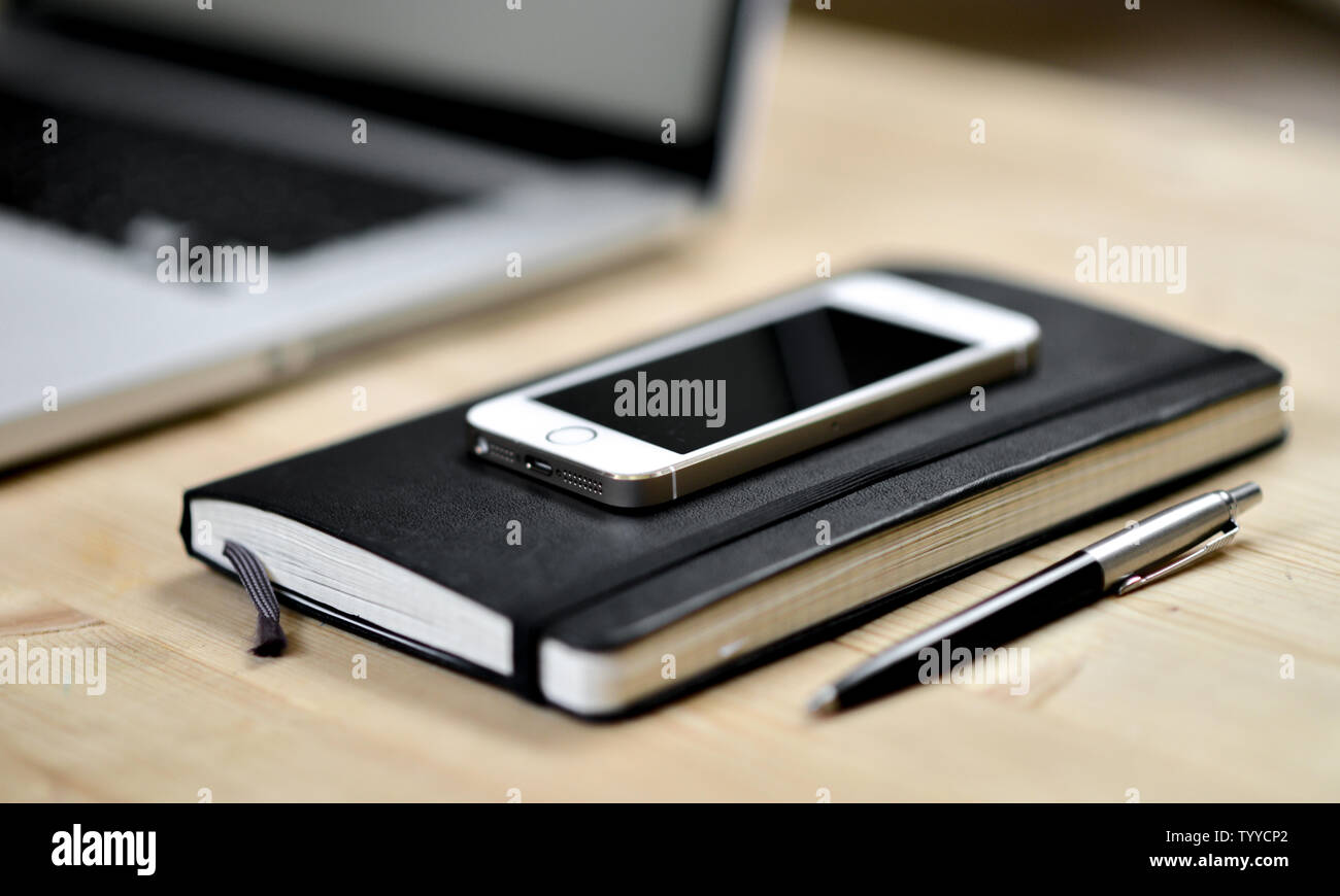 Notebooks and cell phones on the desk Stock Photo - Alamy