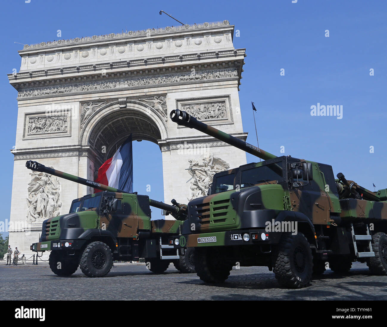 French military vehicles pass the Arc de Triomphe during the annual ...