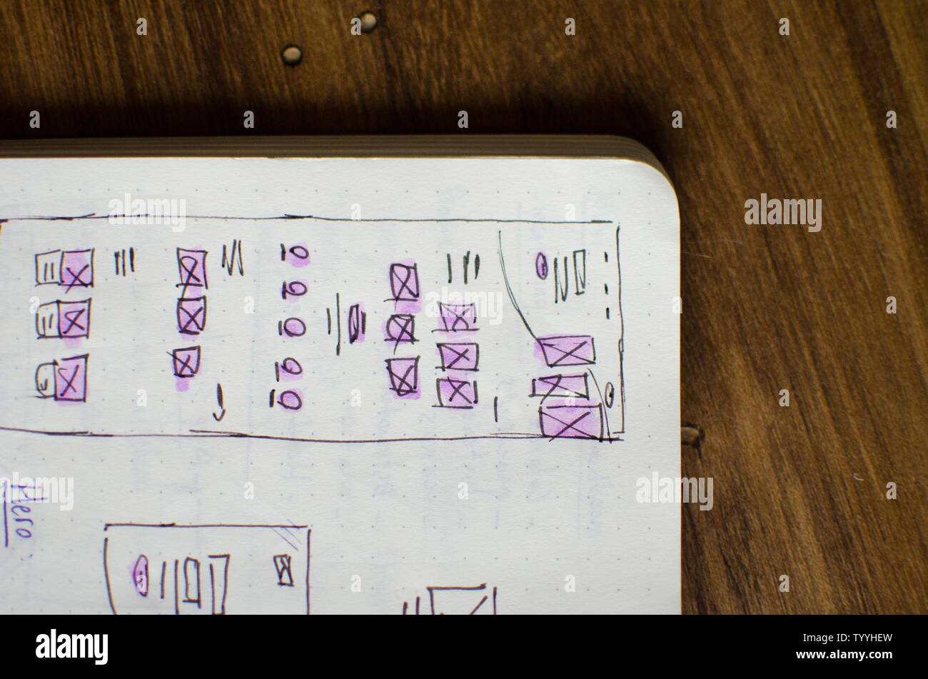 Closeup of UI/UX draft sheet with highlighted areas with a magic marker ...