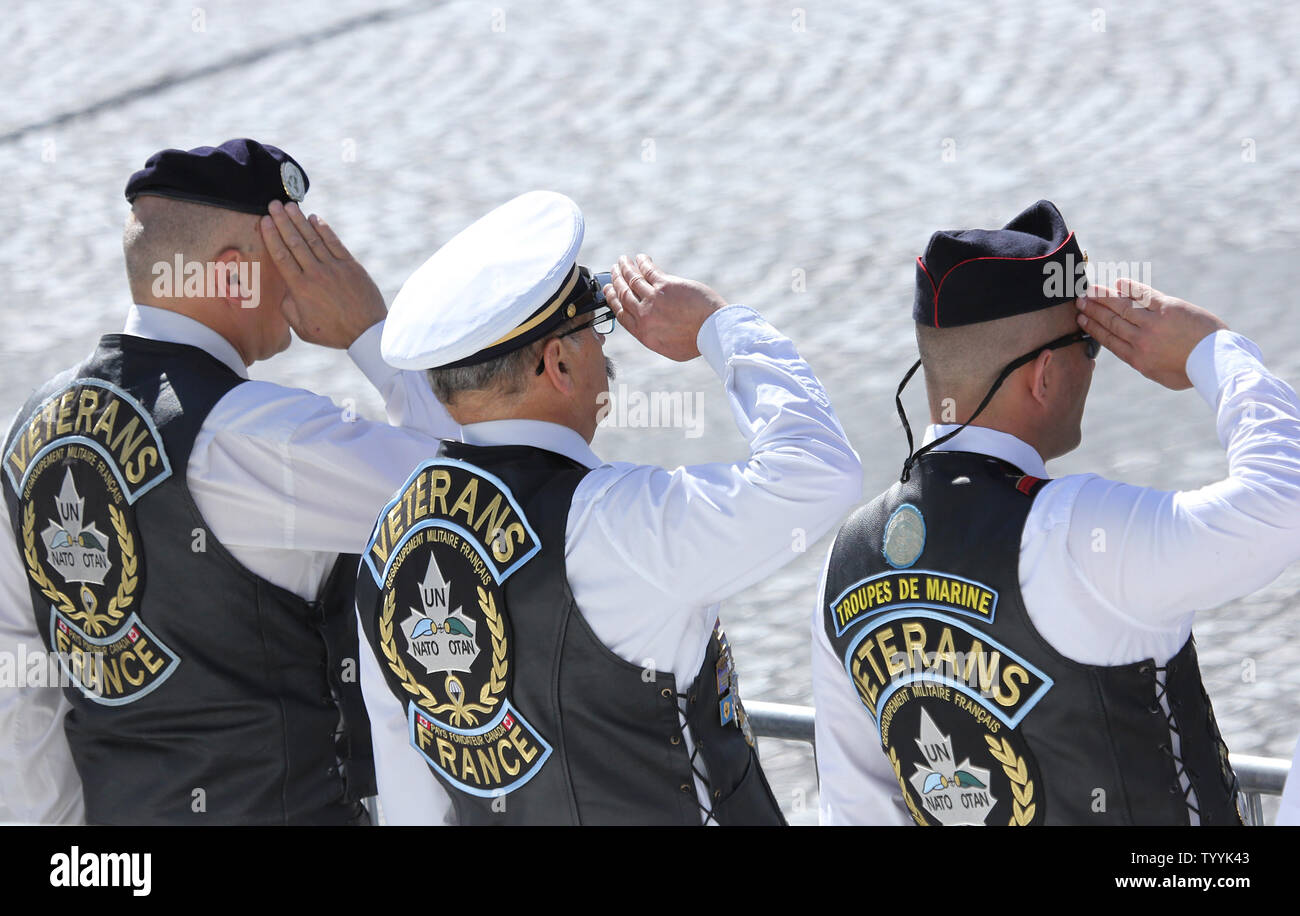 French military veterans salute during a welcome ceremony for Britain's ...