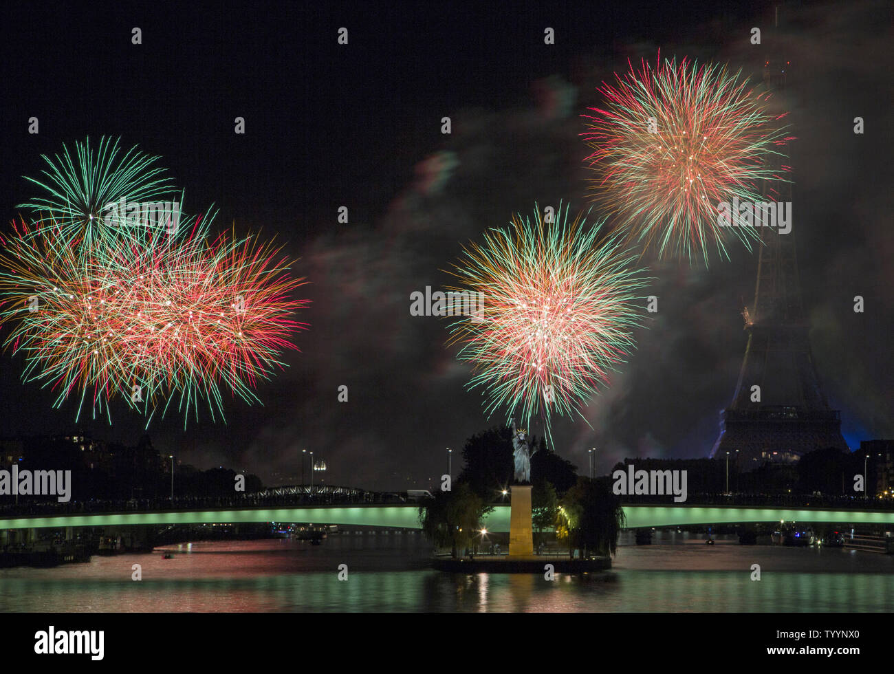 Fireworks explode around the Eiffel Tower during the annual Bastille ...