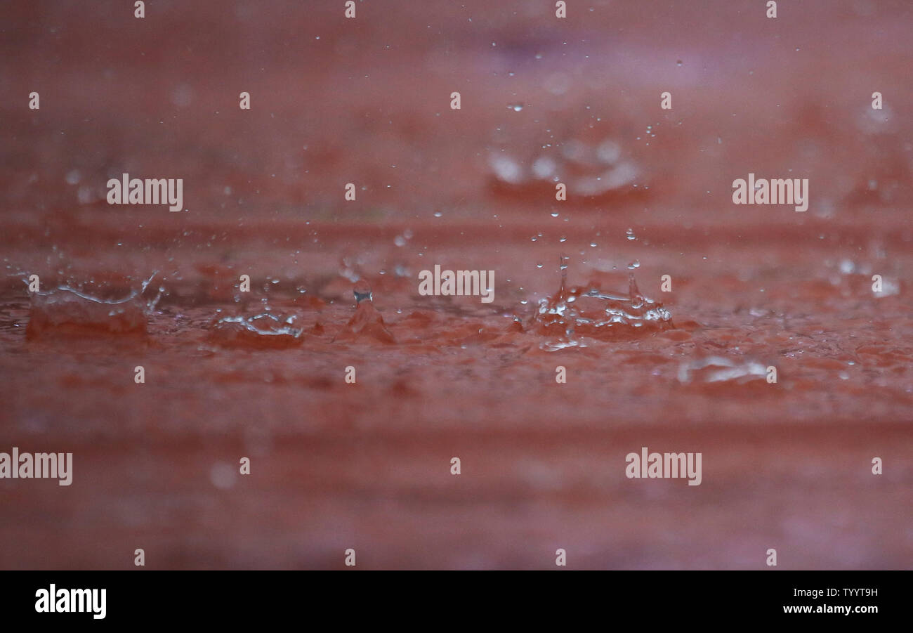 Raindrops fall on the clay of court Philippe Chatrier at Roland Garros ...
