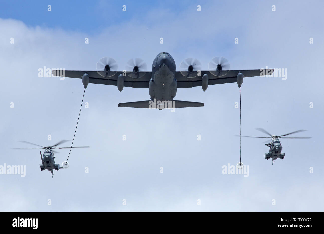 A French military aircraft, trailed by two military helicopters, fly ...