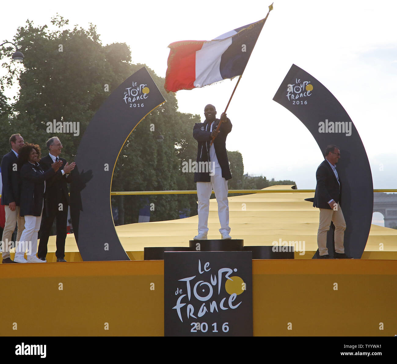 French judo champion Teddy Riner waves the French flag on the ...