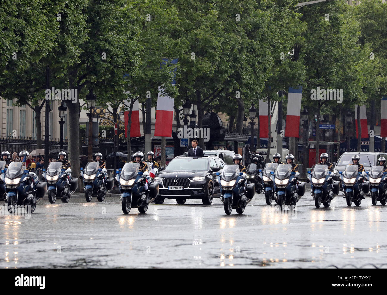 France's new president Emmanuel Macron stands out of the roof of his ...