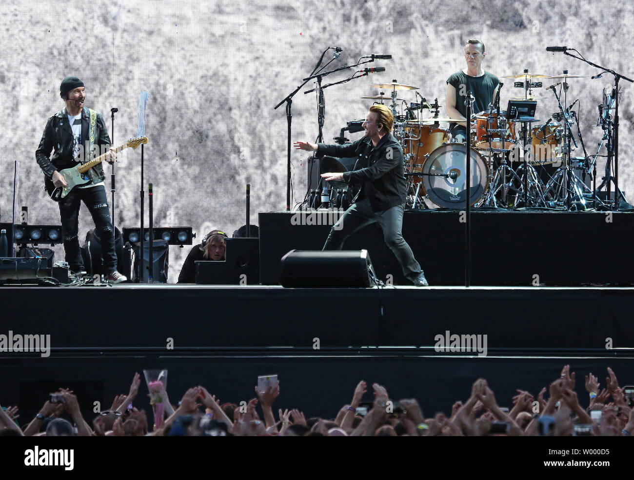 U2 members The Edge (L), Bono (C) and Larry Mullen Jr perform in ...