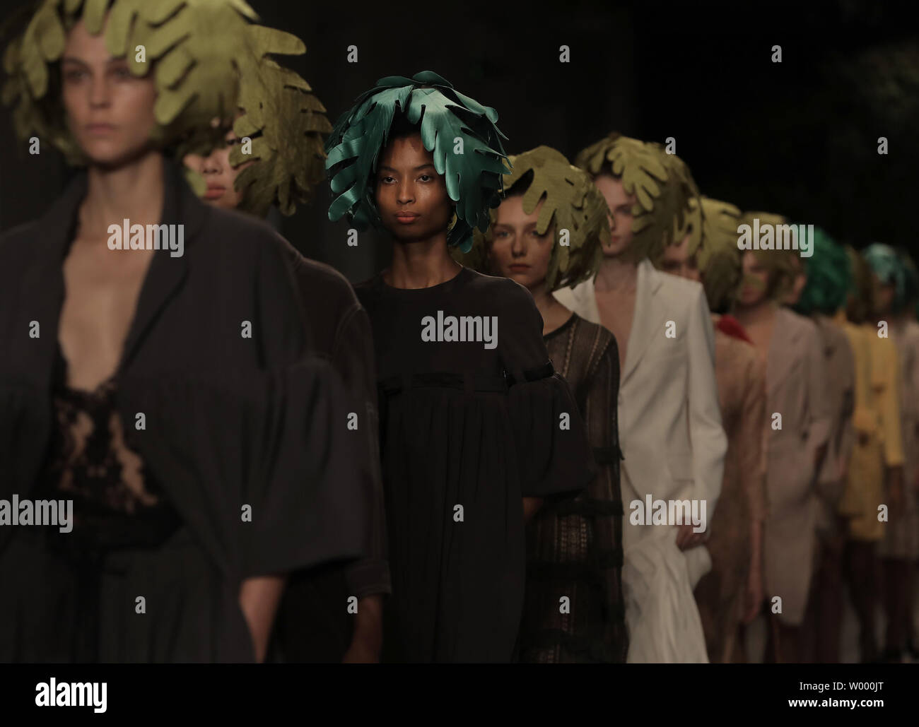 Models line up at the end of the presentation of Junko Shimada's show ...