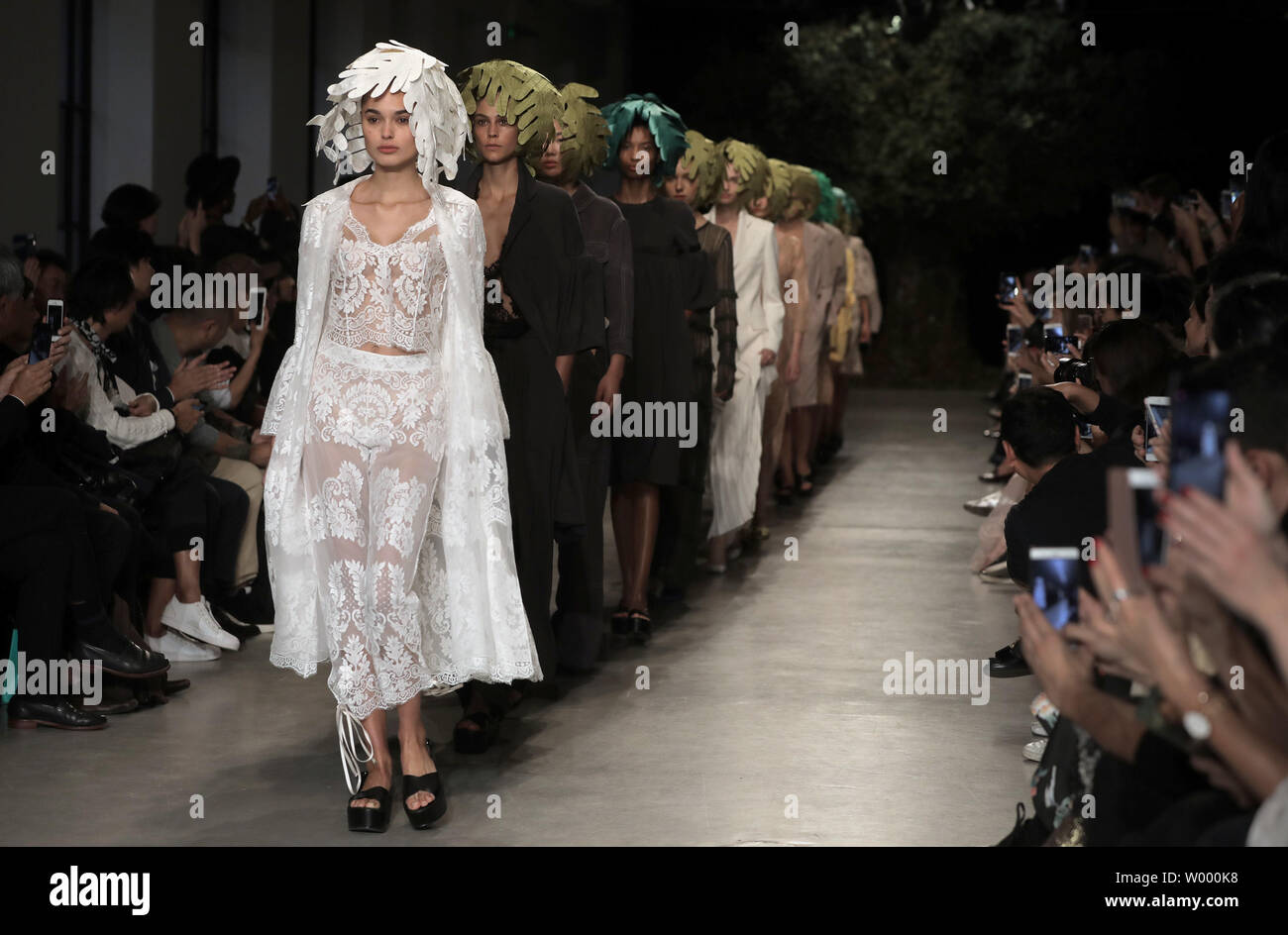 Models line up at the end of the presentation of Junko Shimada's show ...