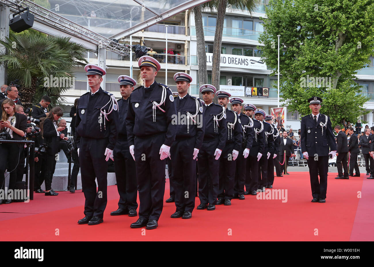 French police officers arrive on the red carpet before the screening of ...