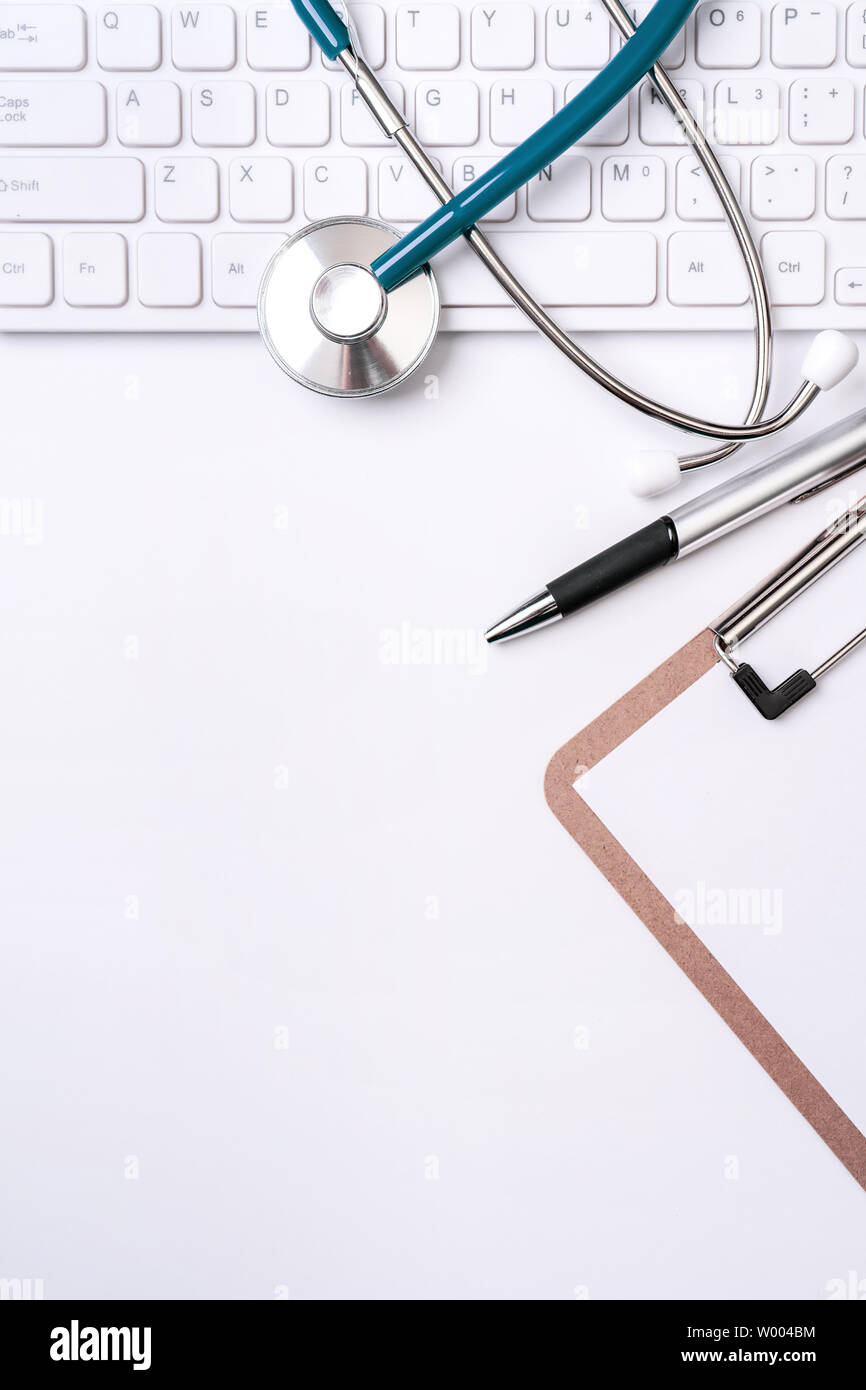 Stethoscope on keyboard on white table background. Online medical ...