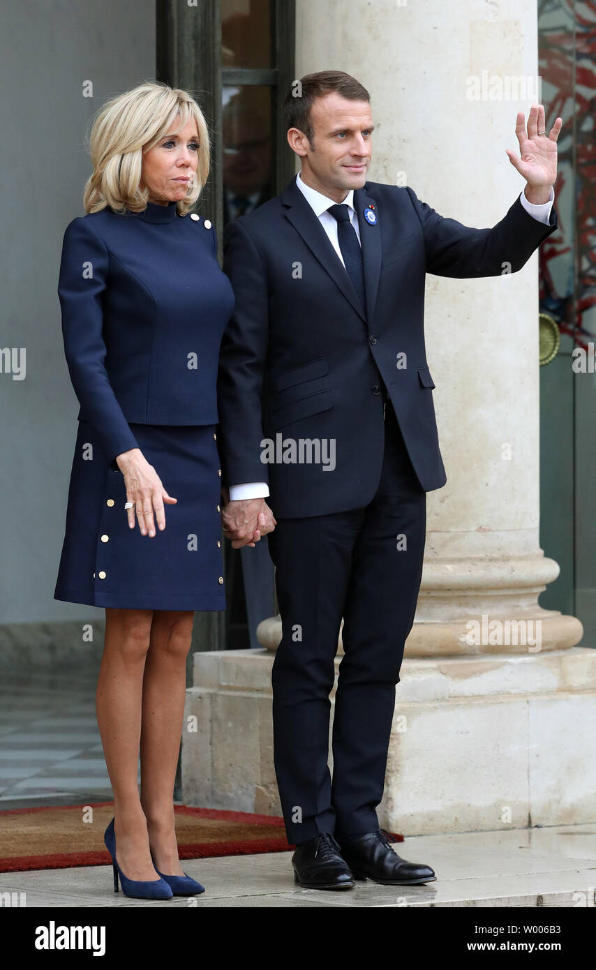 French President Emmanuel Macron (R) and his wife, Brigitte, bid ...