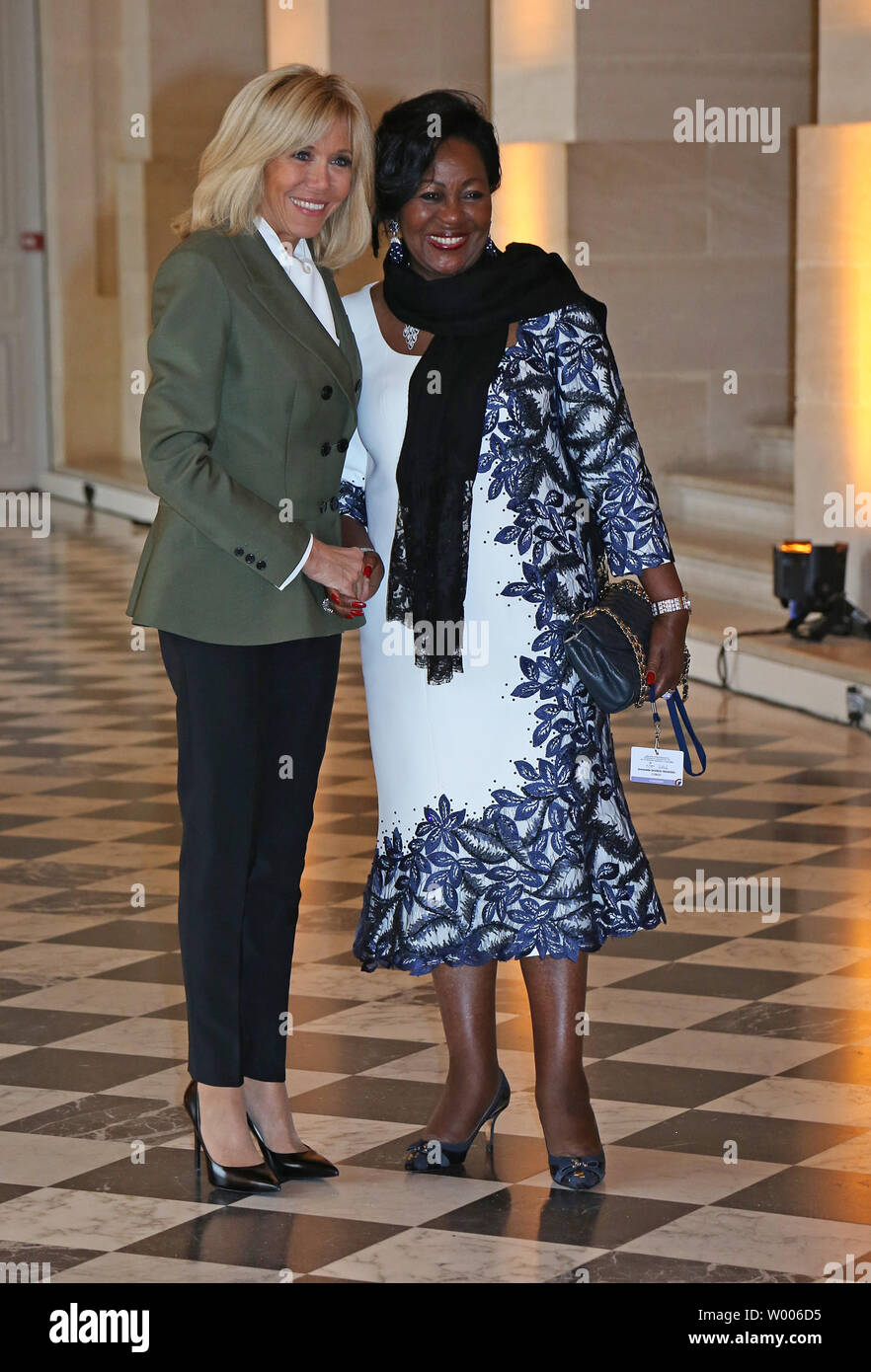 Brigitte Macron (L), wife of French President Emmanuel Macron, greets ...