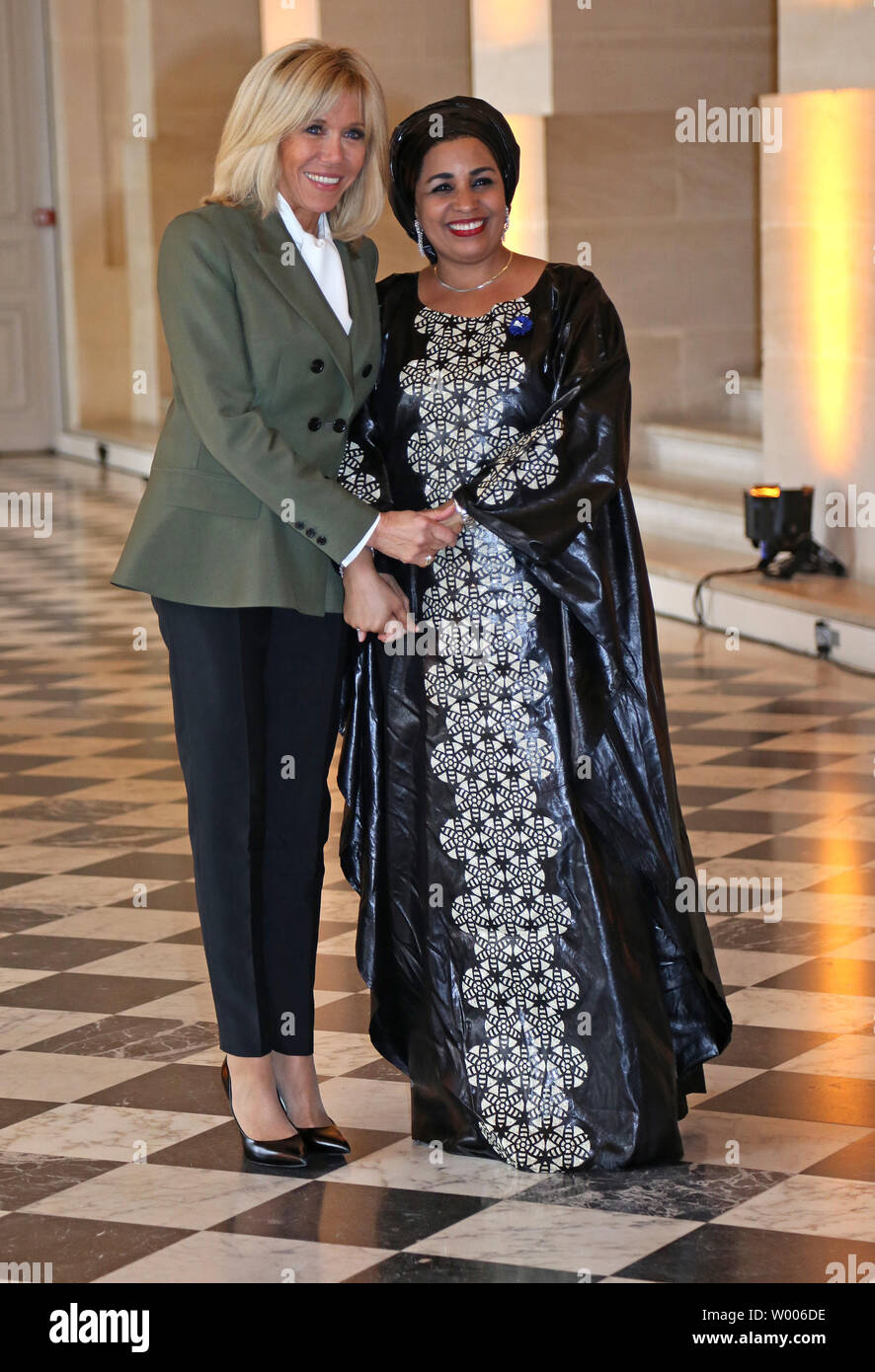 Brigitte Macron (L), wife of French President Emmanuel Macron, greets ...