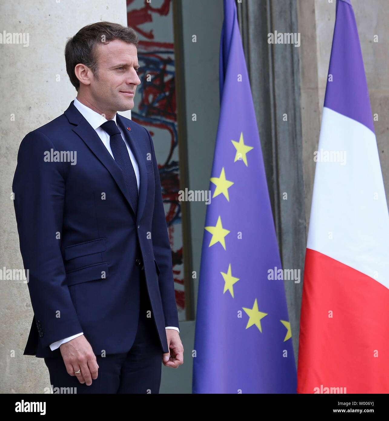 French President Emmanuel Macron arrives on the steps of the Elysee ...
