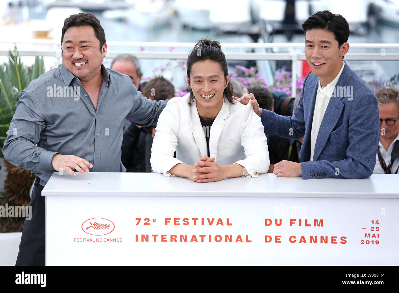 Don Lee (L), Sung Kyu Kim (C) and Moo Yul Kim arrive at a photocall for ...