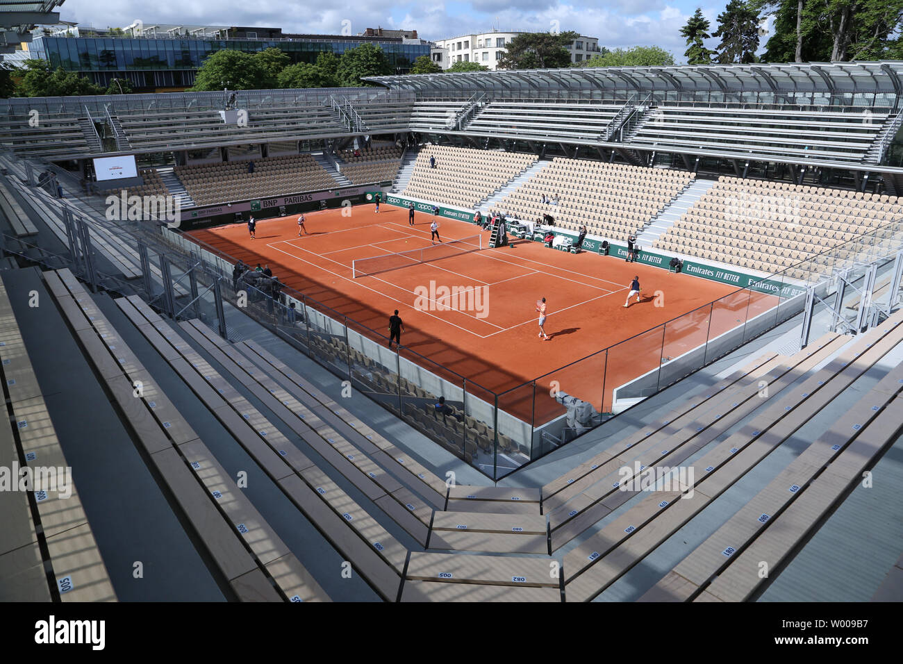 Players warm up on the newly-inaugurated Court Simonne-Mathieu during ...