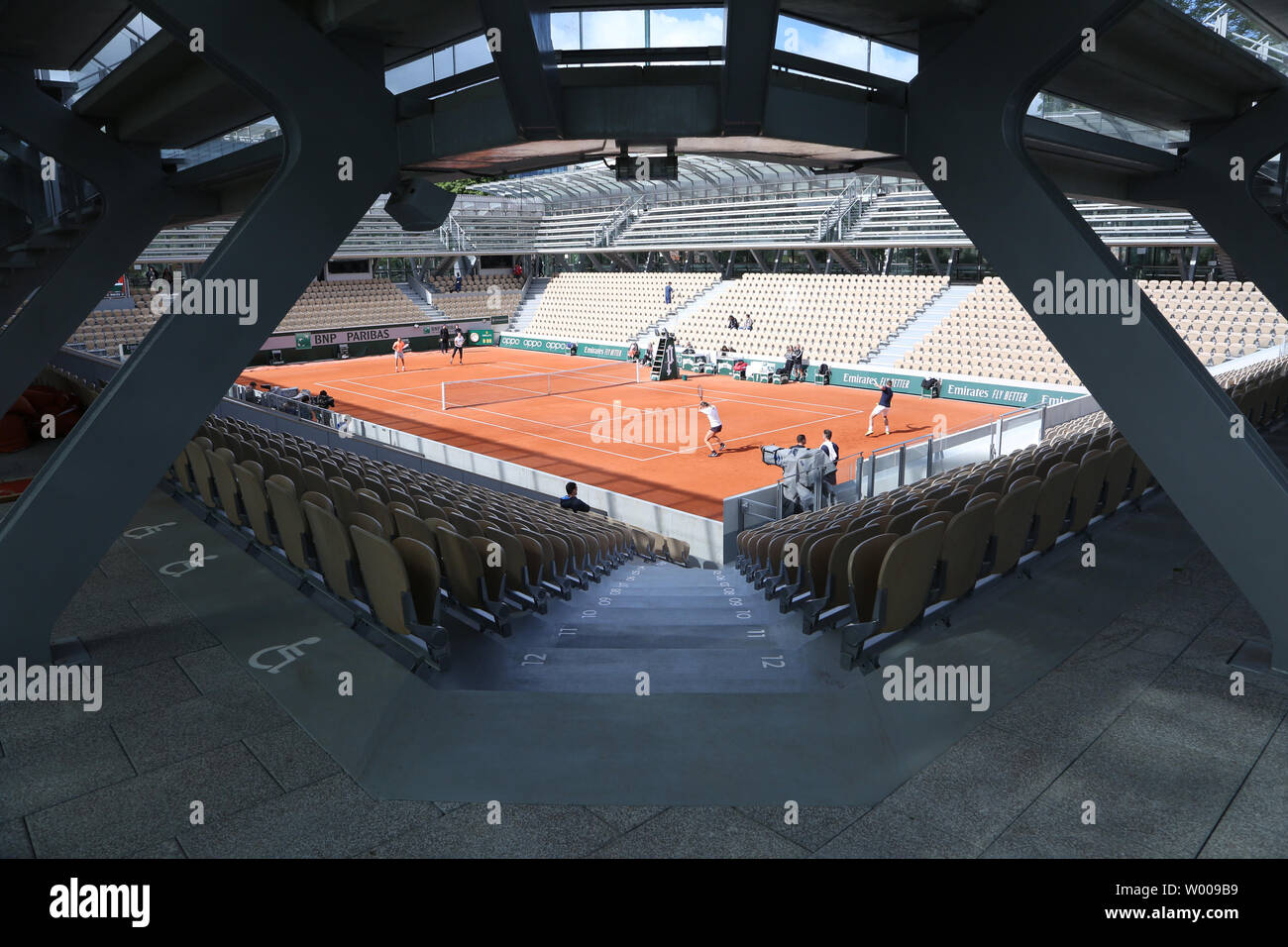 Players warm up on the newly-inaugurated Court Simonne-Mathieu during ...