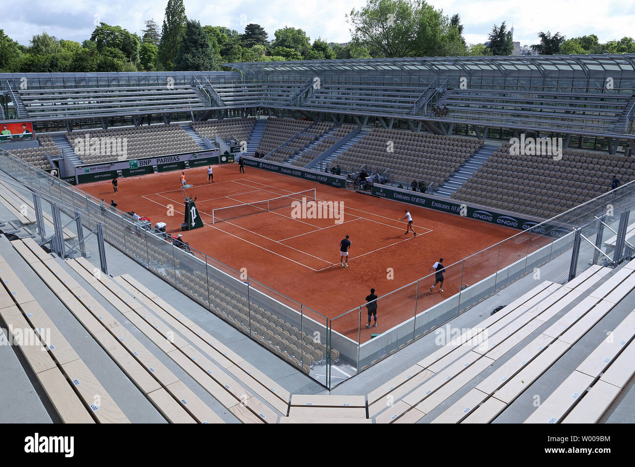Players warm up on the newly-inaugurated Court Simonne-Mathieu during ...