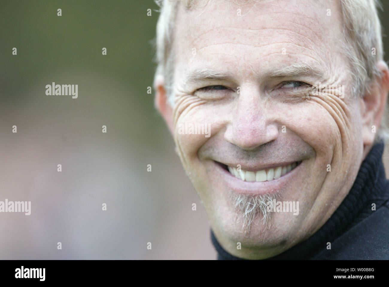 Kevin Costner smiles with friends on the practice green before the AT&T ...