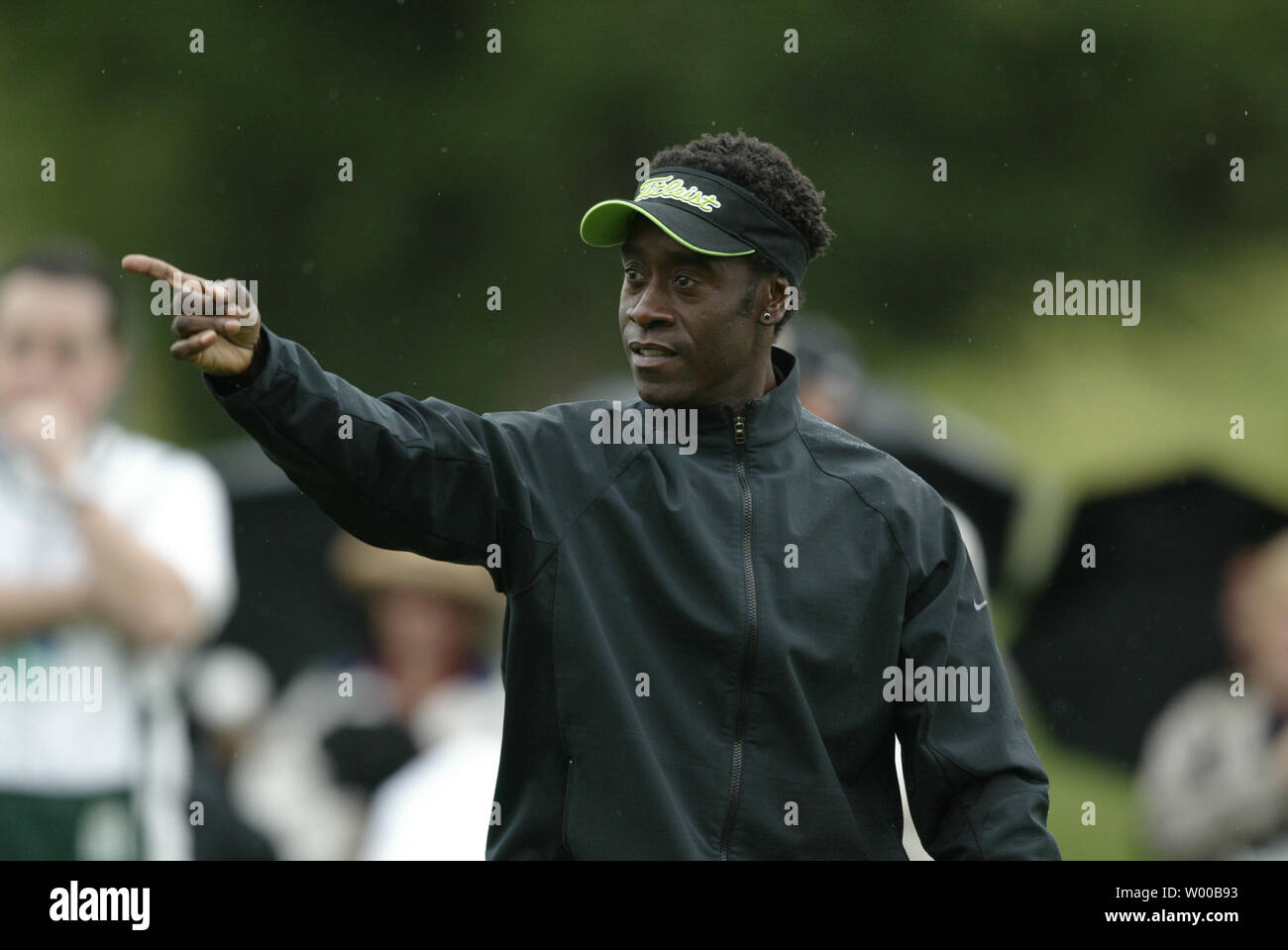Don Cheadle points towards cheering fans in the gallery after sinking a ...