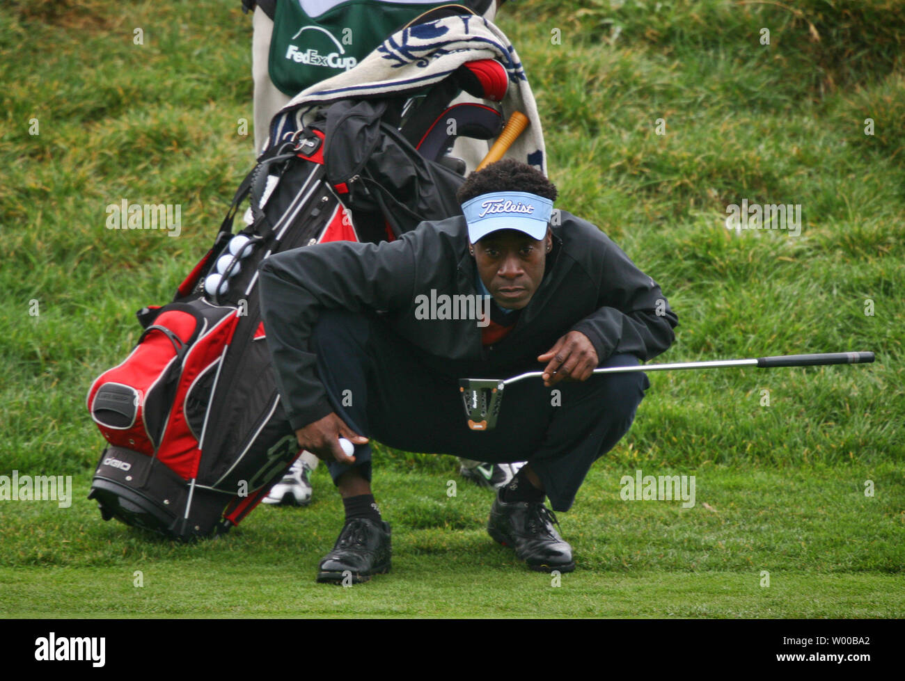 Don Cheadle lines up his putt on the 3rd hole of Spyglass Hill during ...