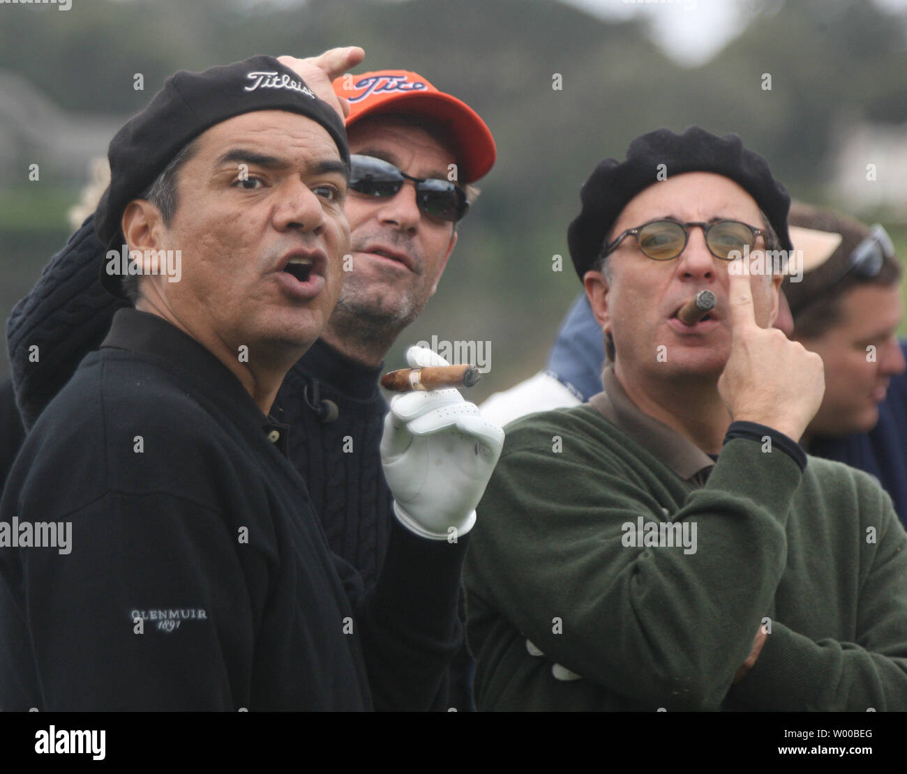 Actors George Lopez (L) and Andy Garcia smoke cigars as rocker Huey ...