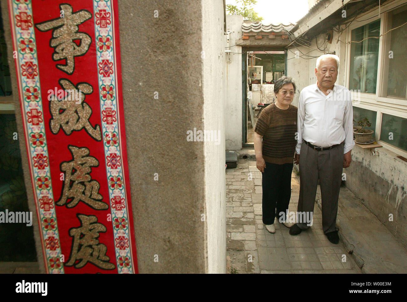 Zheng Zhanlin, 75, (R) and his wife Wu Shuqin, 77, stand in their soon ...