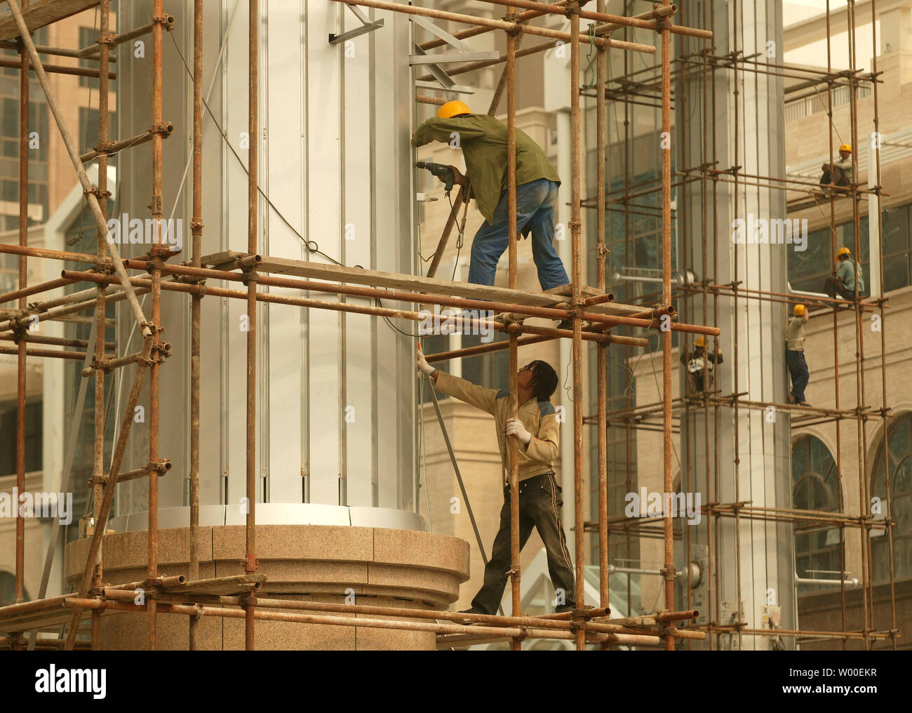 Chinese construction workers put the finishing touches on massive ...