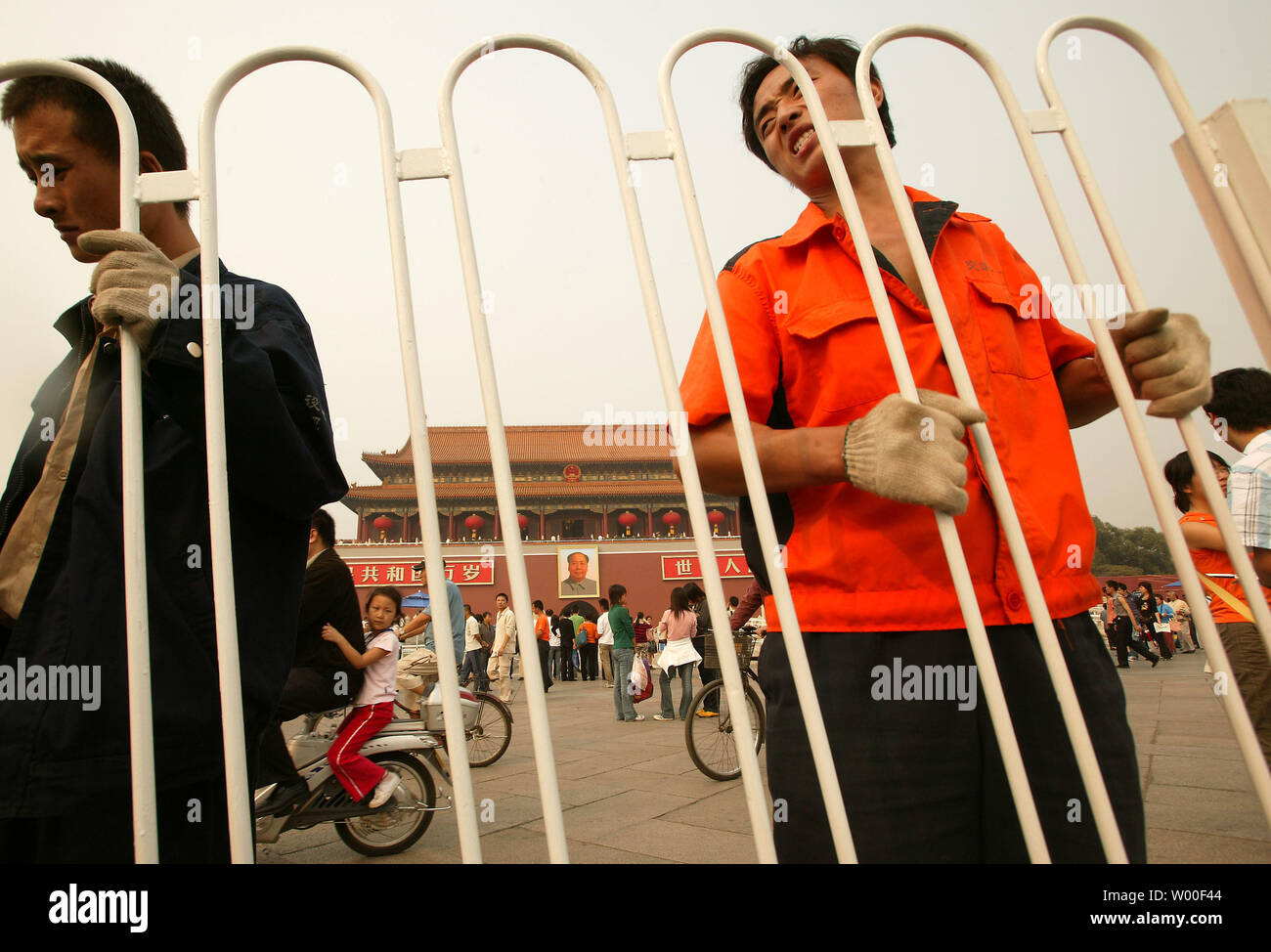 Chinese workers assemble crowd-control barricades in front of Tiananmen ...