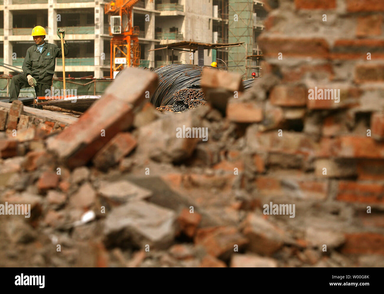 A construction worker surveys the demolition of an old Chinese ...